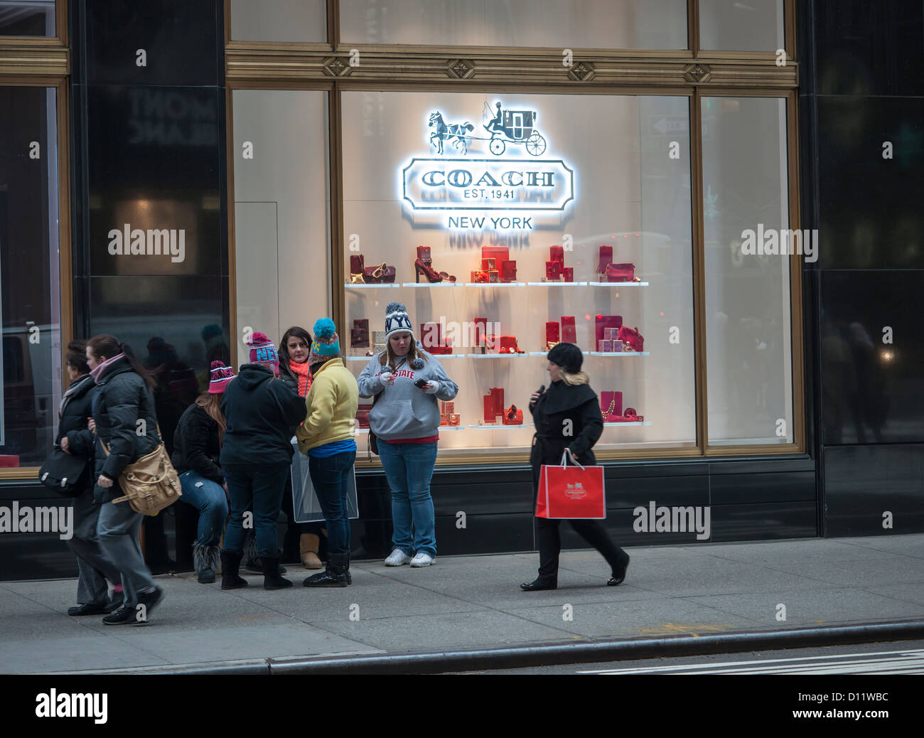 Shoppers outside the Coach store on Madison Avenue in New York during ...