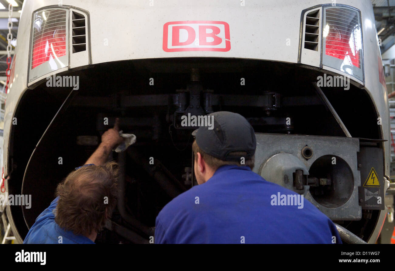 Employees of German railway company Deutsche Bahn AG do maintenance ...