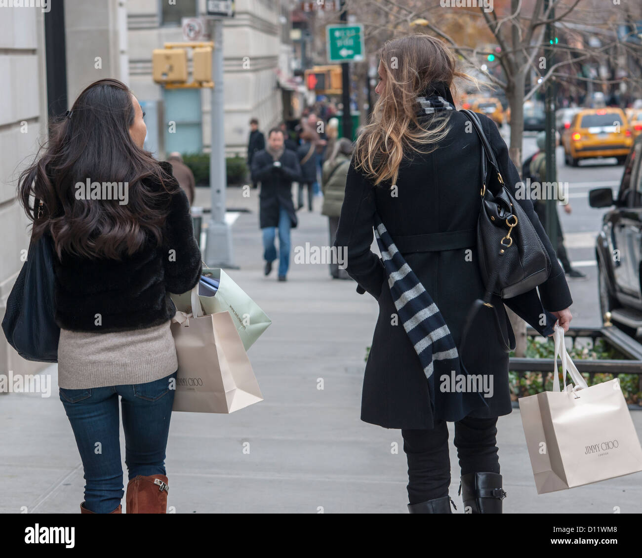 Shoppers with their Jimmy Choo purchases on Madison Avenue in New York ...
