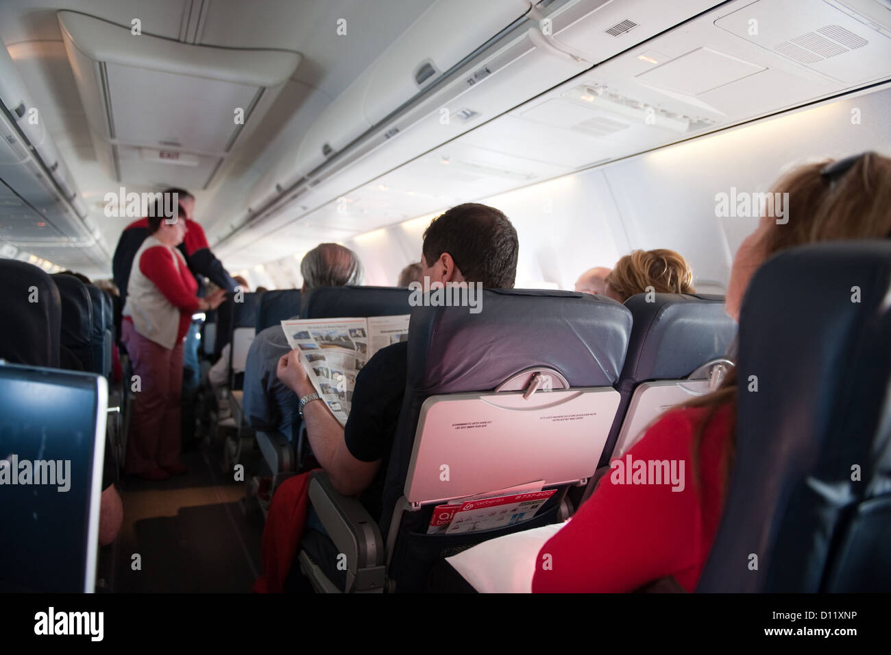 Interior of airplane with passengers hi-res stock photography and ...