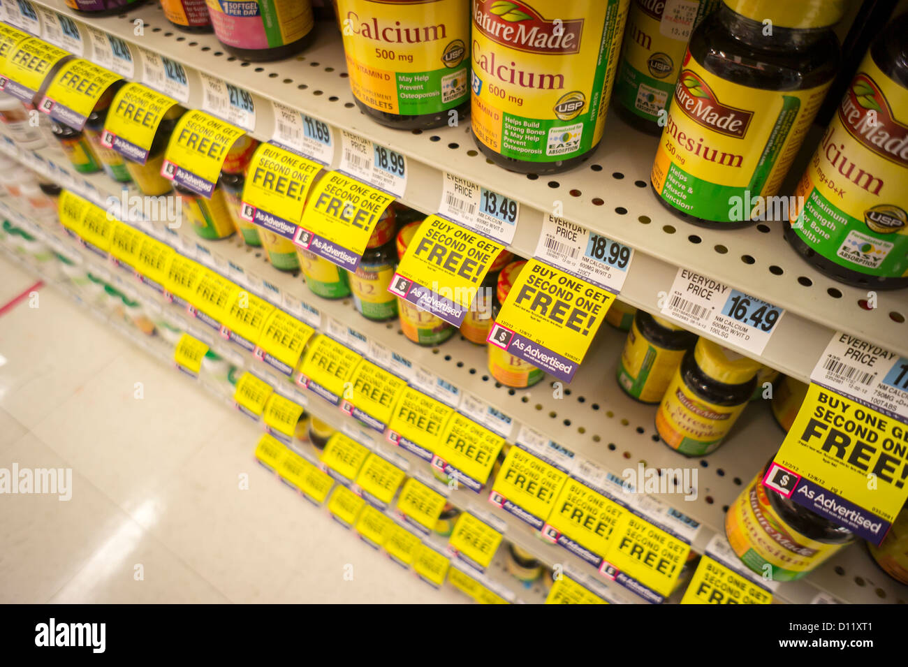Vitamins and other supplements are seen on the shelves of a drugstore ...