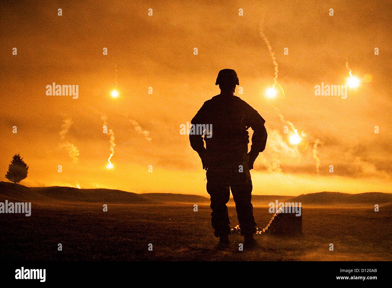 A US Army Soldier watches flares light up the sky during the Department ...