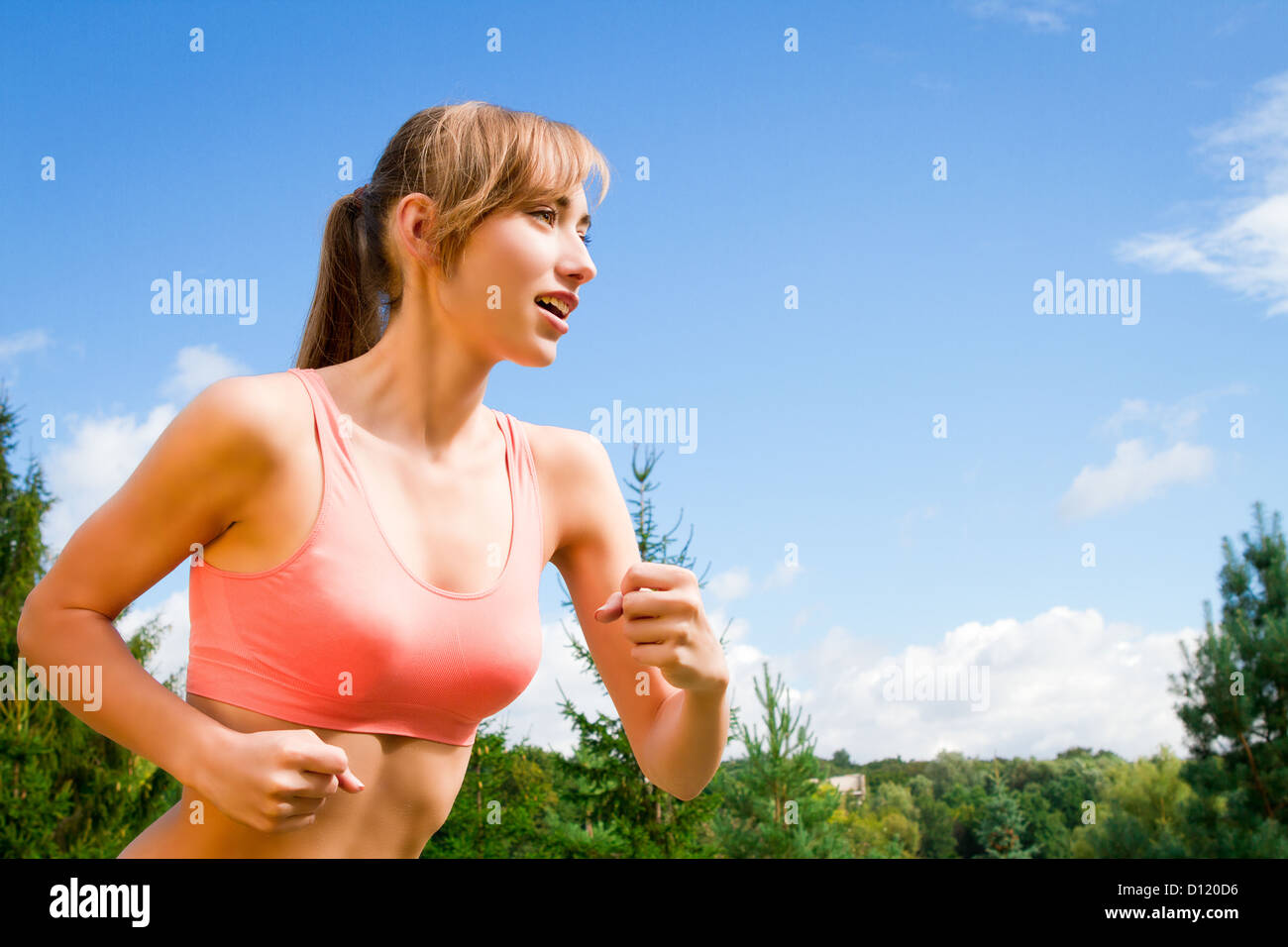 Pretty young woman runner in the forest Stock Photo - Alamy