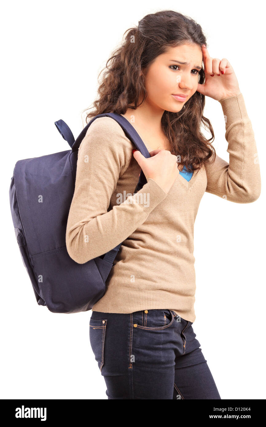 A sad female teenager with a school bag on her back posing isolated on ...