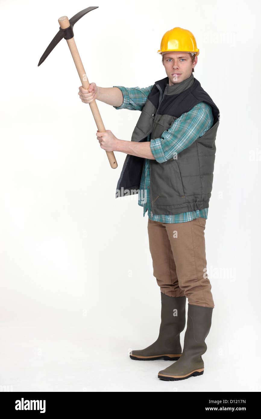 Man holding pick axe Stock Photo - Alamy