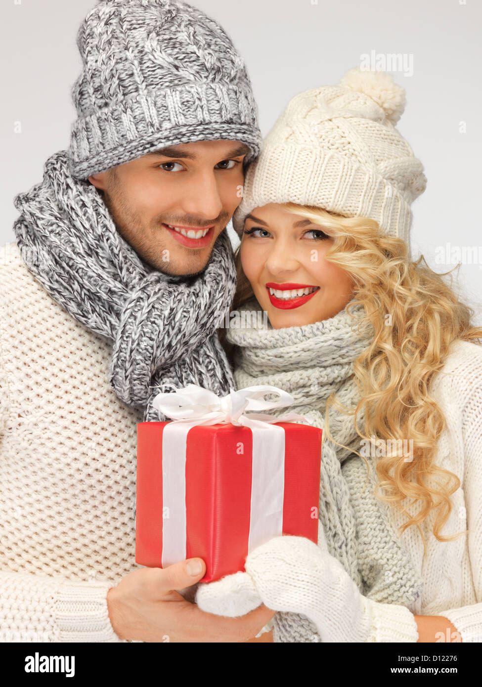 romantic couple in a sweaters with gift box Stock Photo - Alamy
