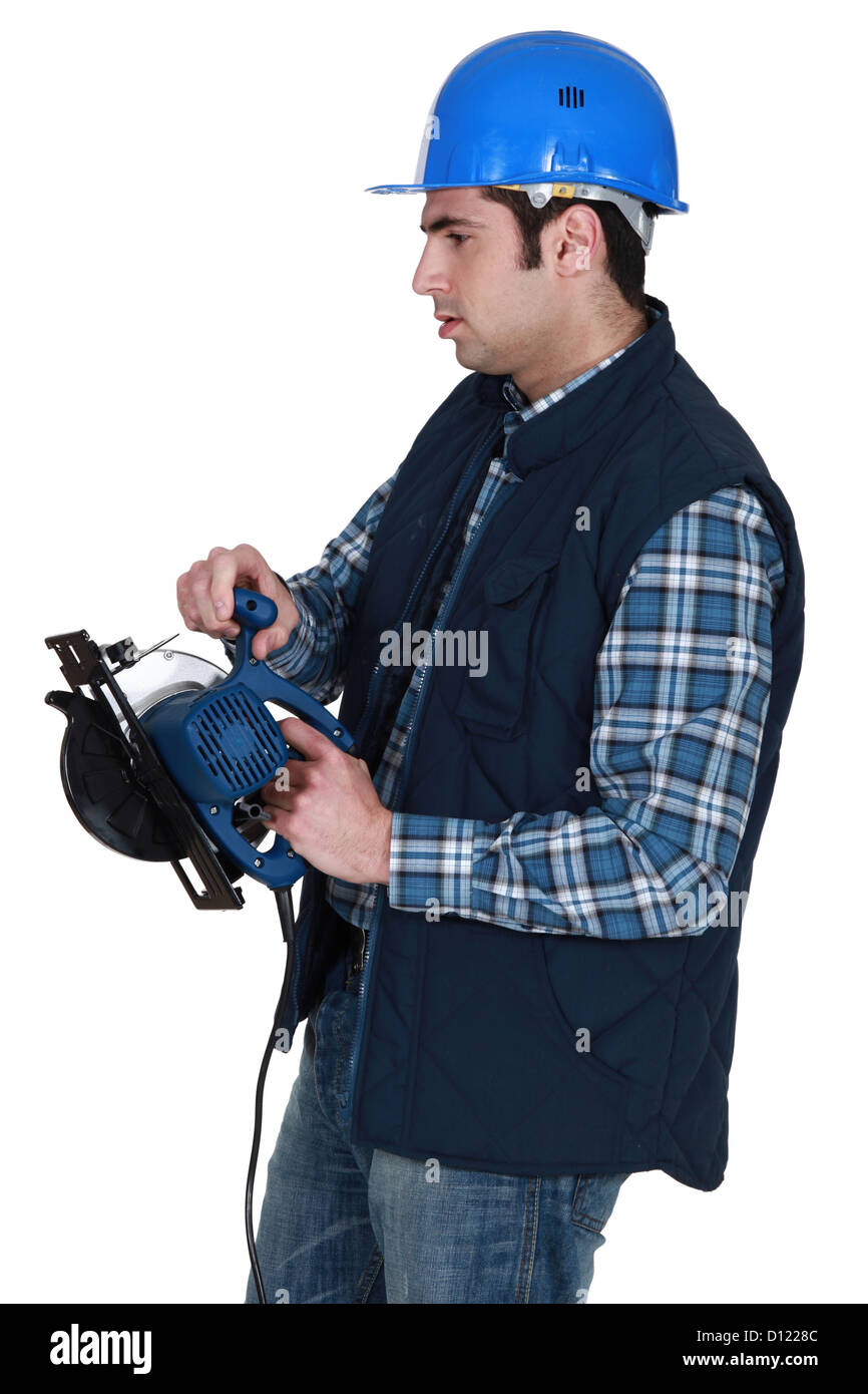 Man holding circular saw Stock Photo - Alamy