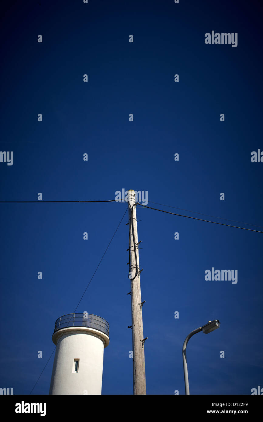 Telephone pole with street light and former lighthouse Stock Photo - Alamy