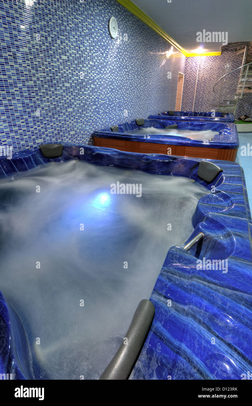 Luxurious blue whirlpool spraying water through numerous jets Stock ...