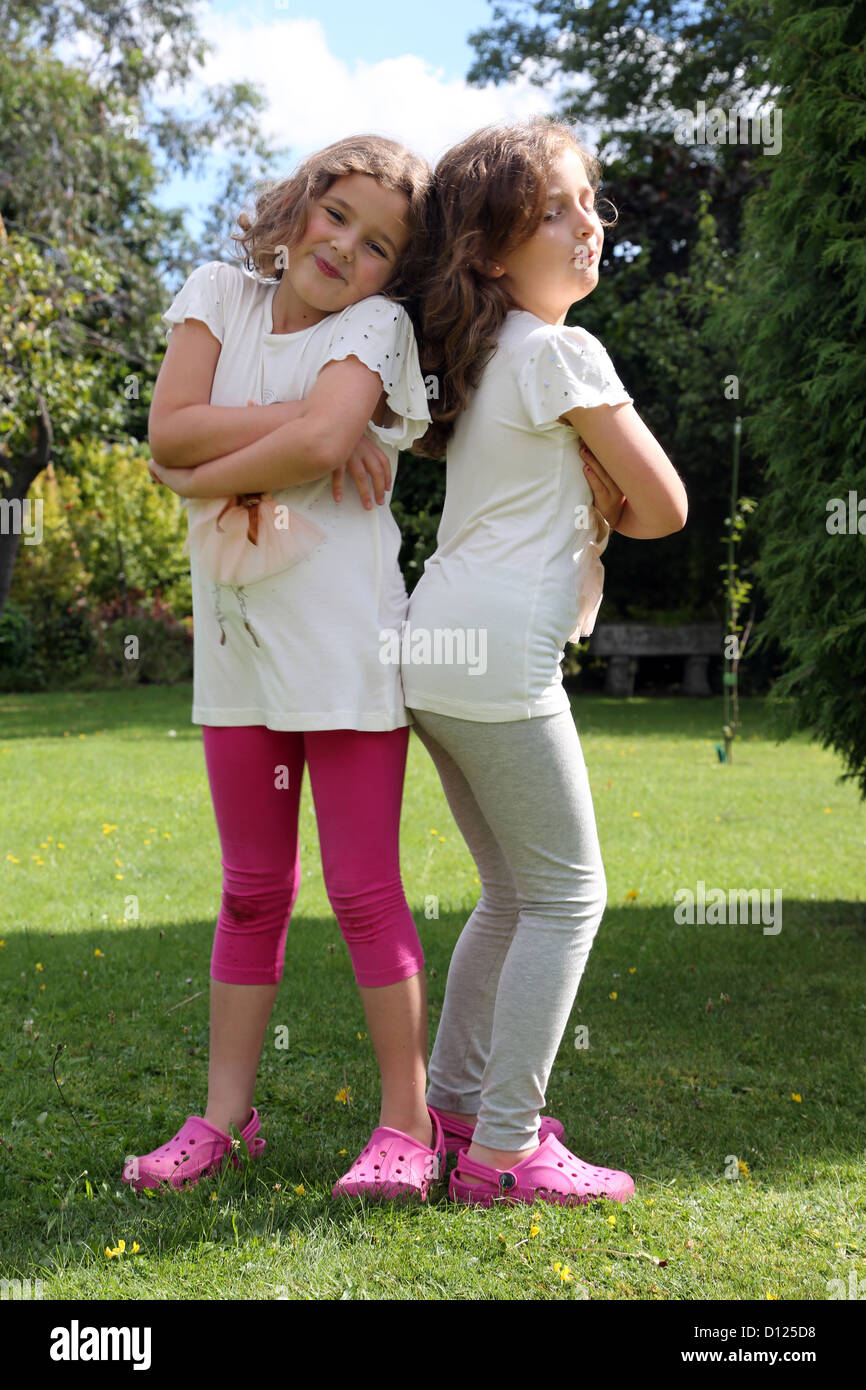 Sisters back back arms crossed hi-res stock photography and images - Alamy
