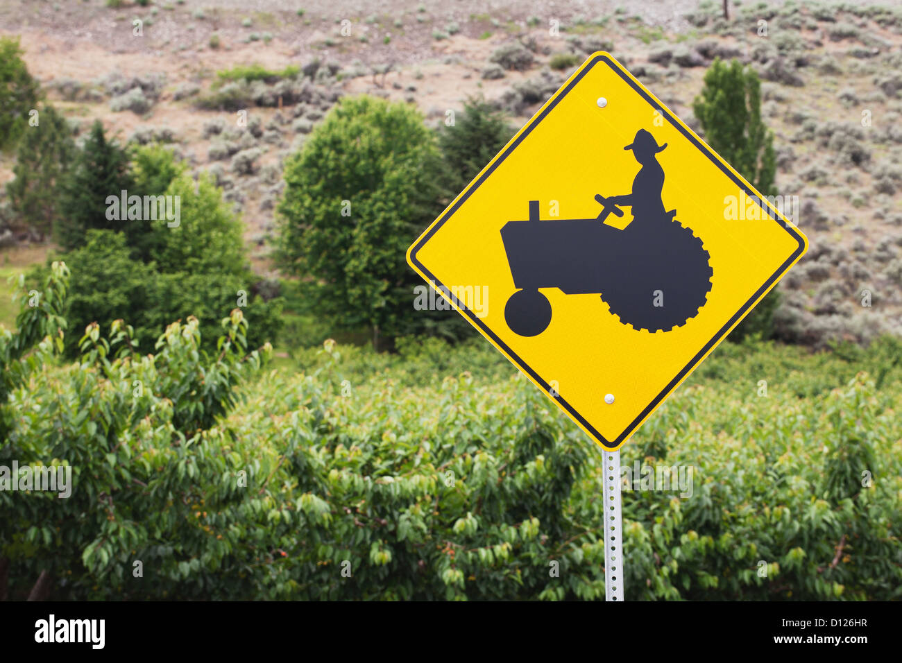 Farmer And Tractor Road Sign With Shrubs And Gravel Hillside In The ...
