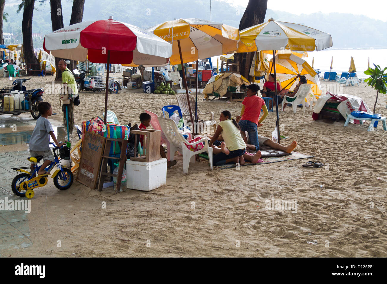 Tourists Enjoying A Traditional Thai Massage On The Beach Of Patong On