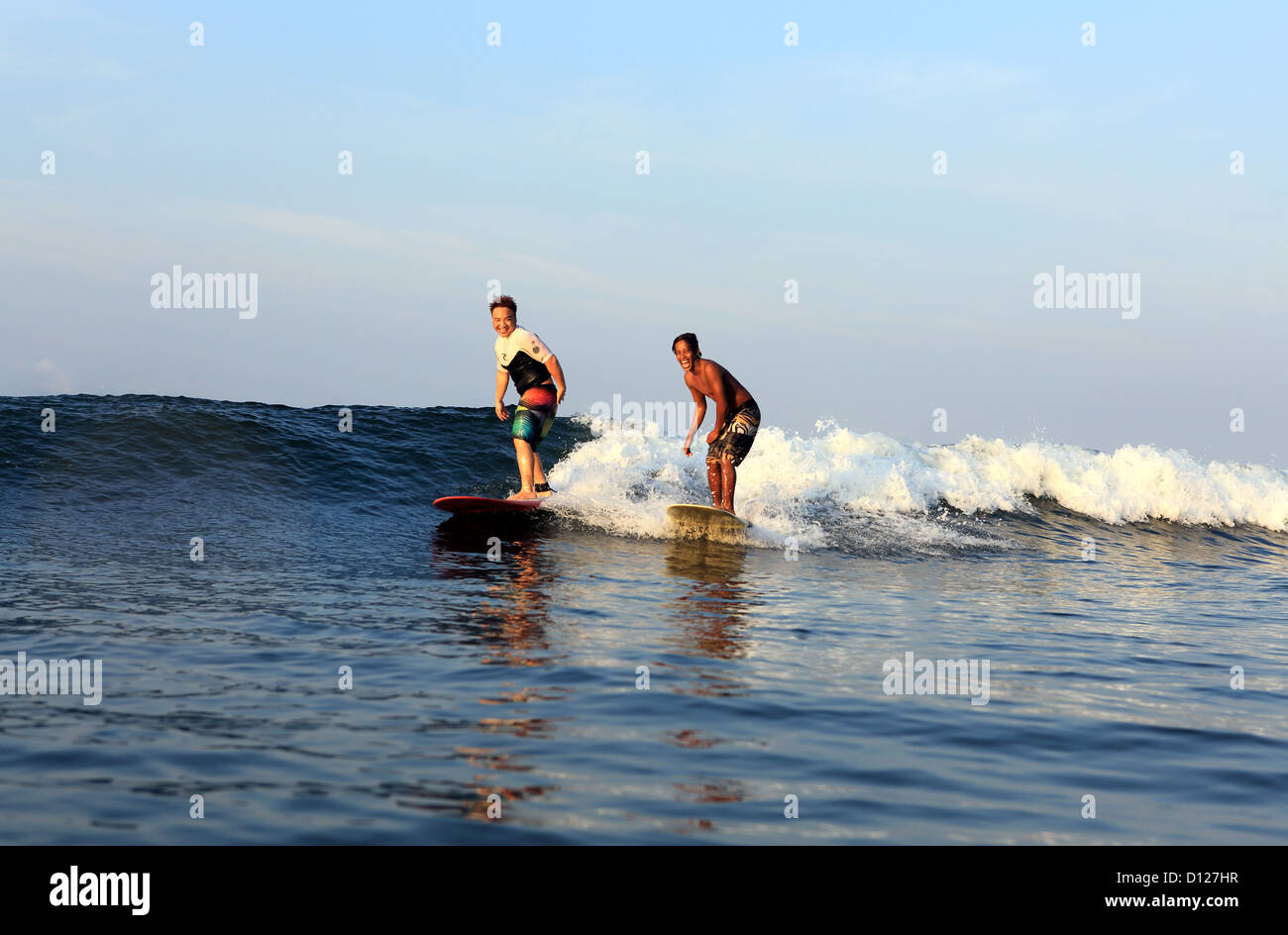 Longboard surfer surfing a wave in Batu Karas on the south coast of ...