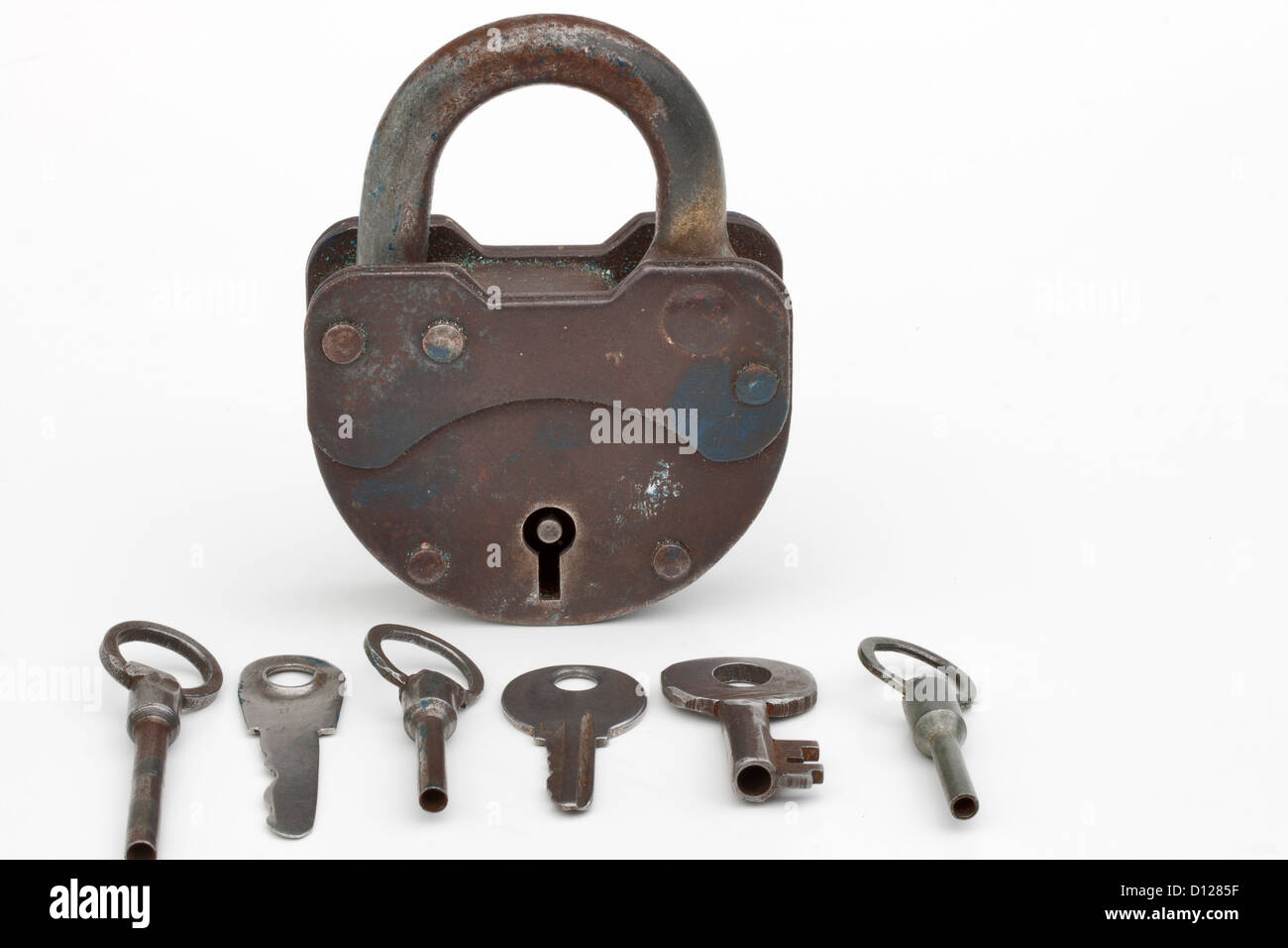 Old rusty padlock and set of six keys closeup against white background ...