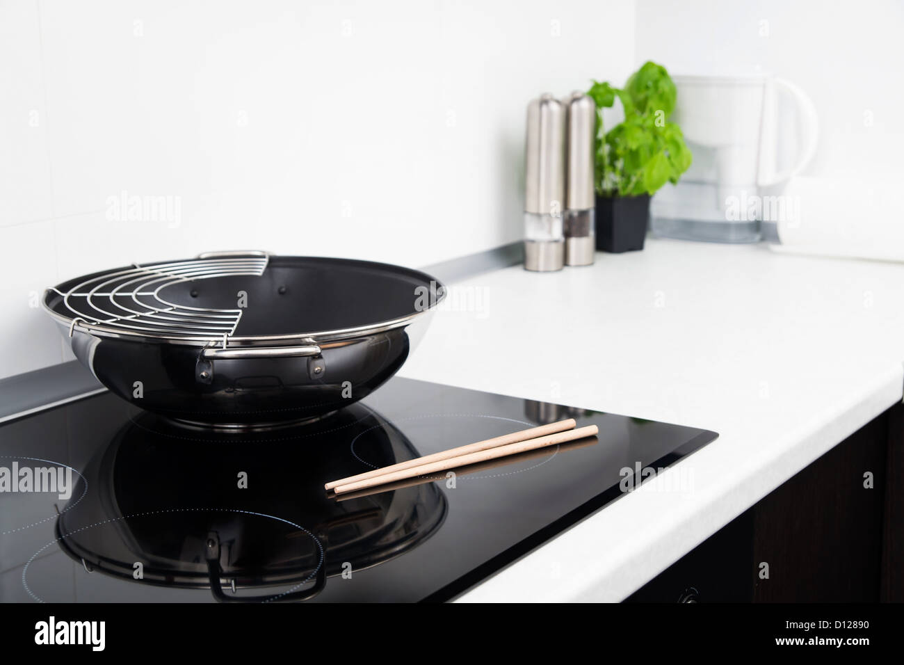Frying pan and sticks in modern kitchen with induction stove Stock ...