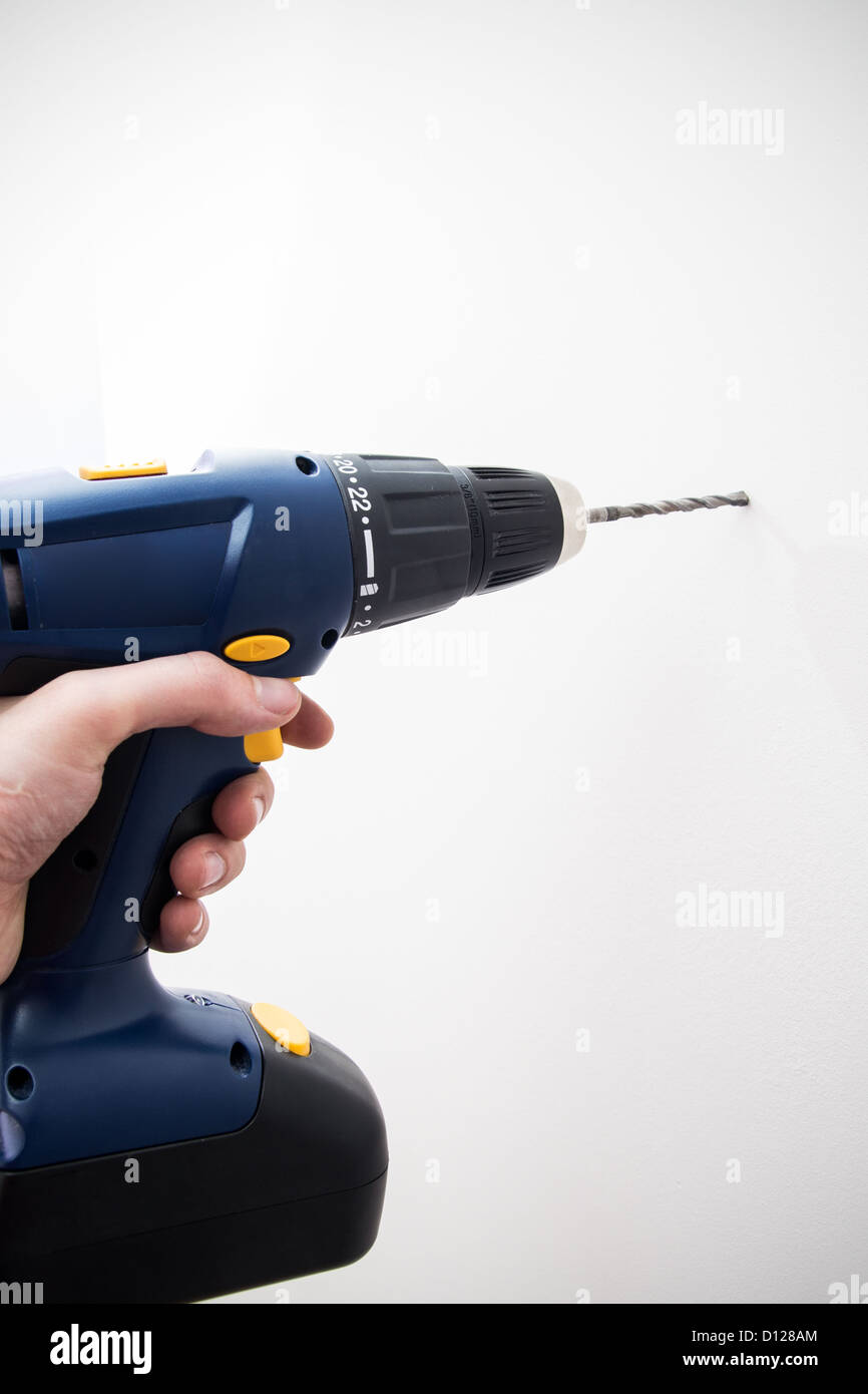 Man's hand holding blue drill Stock Photo - Alamy