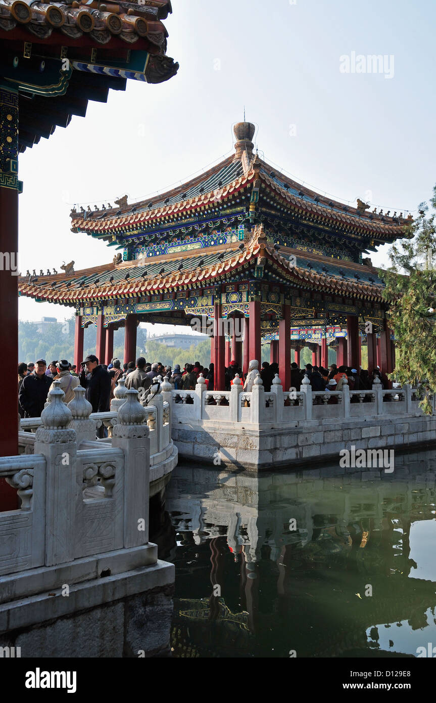A Crowd Gathers Under A Traditional Chinese Structure; Beijing China ...