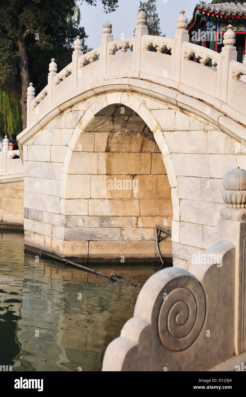 An Arched Bridge With Ornate Railing Going Over Water; Beijing China ...