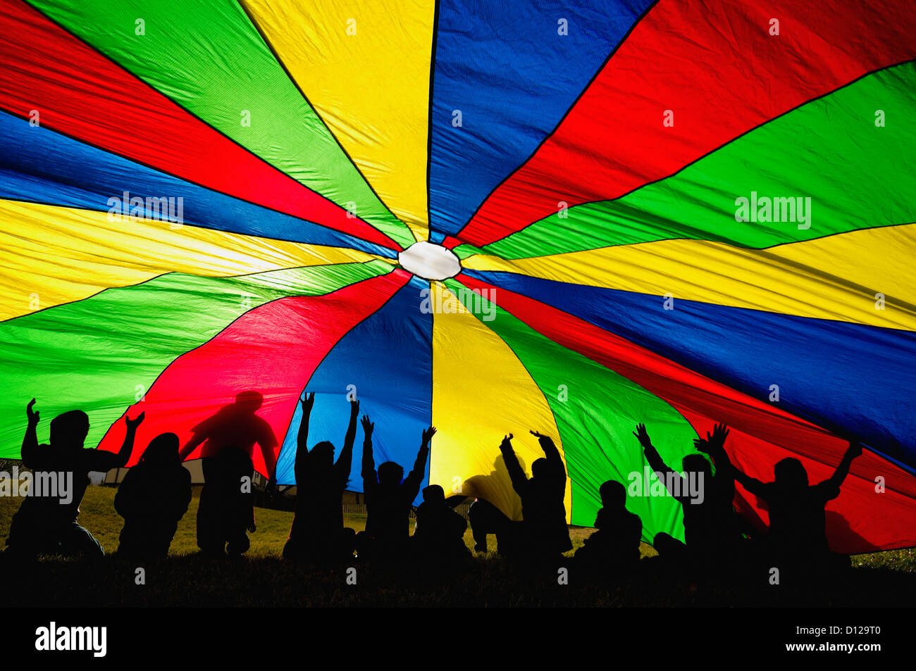 Group children play parachute game hi-res stock photography and images ...