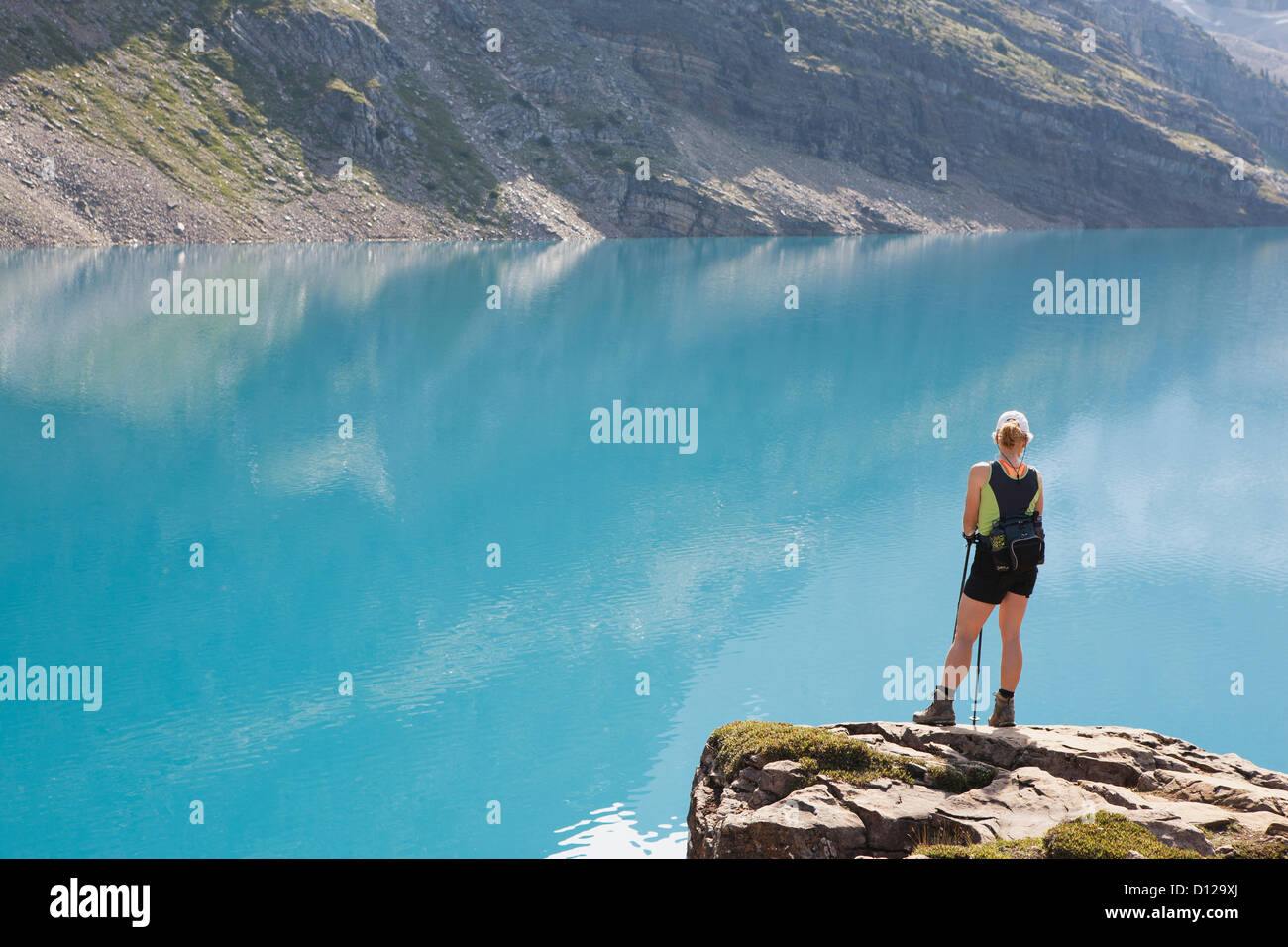 Female Hiker On Rock Cliff Overlooking Mountain Lake; Field British ...