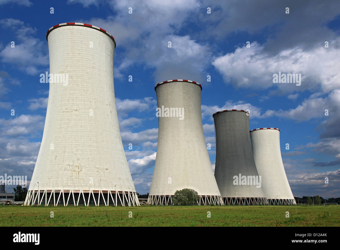 four coal power plant cooling tower under dramatic sky Stock Photo - Alamy