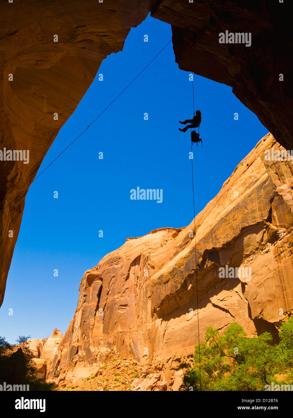 A Female Athlete Rappeling Down A Dry Utah Slot Canyon Waterfall ...