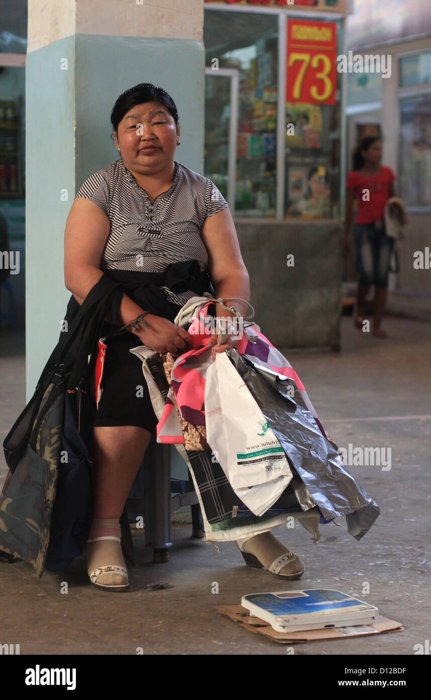Woman with bags and scales, Naran Tuul 'Black' market, Ulaanbaatar ...