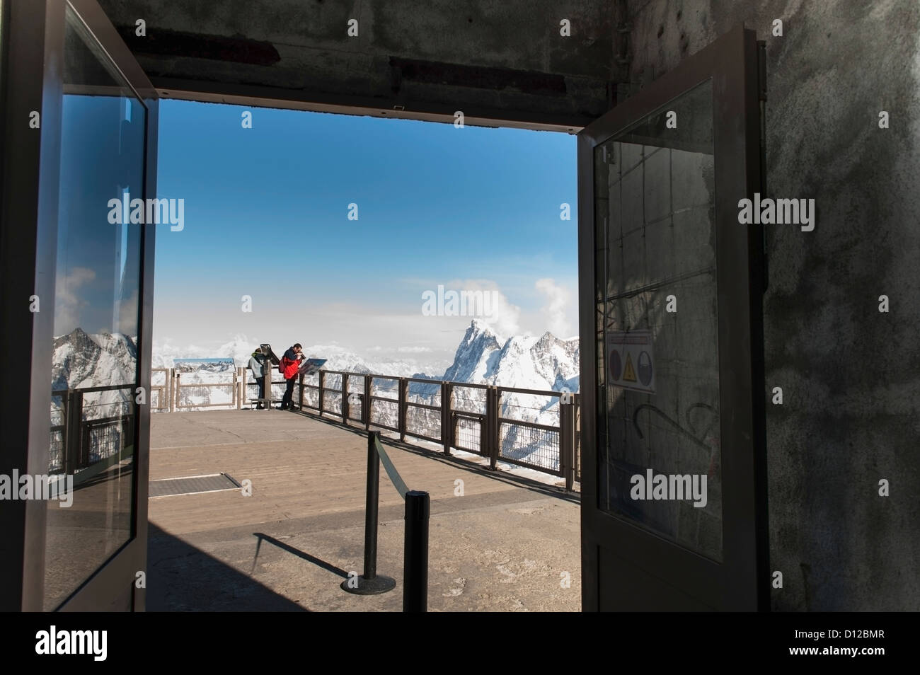 People Peering Over The Edge Of A Railing At The French Alps Mountain ...