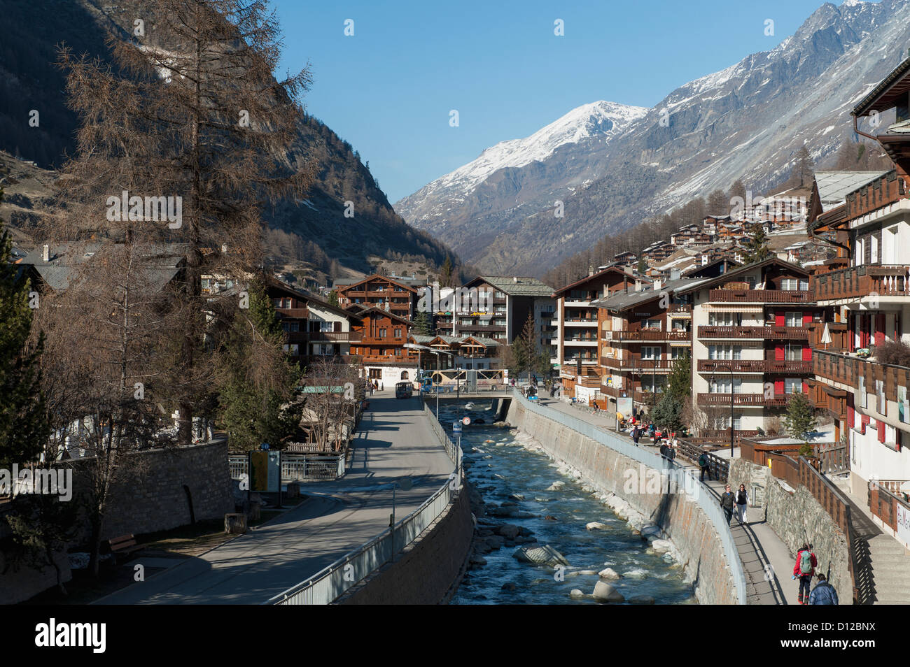 A Waterway Running Through The City With Pedestrians Walking On The ...