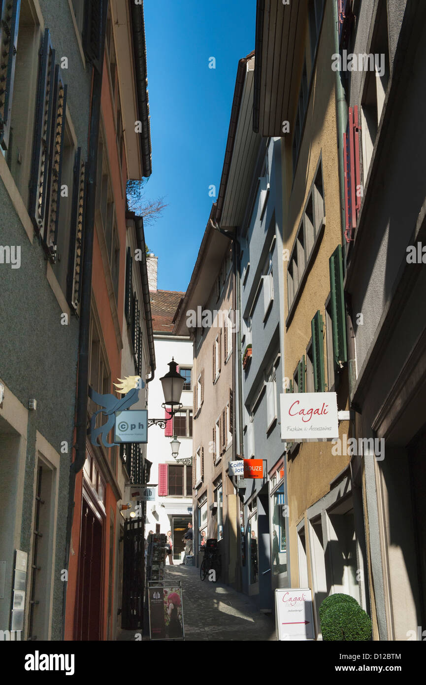 A Narrow Walkway Between Buildings With Retail Signs Mounted To The ...