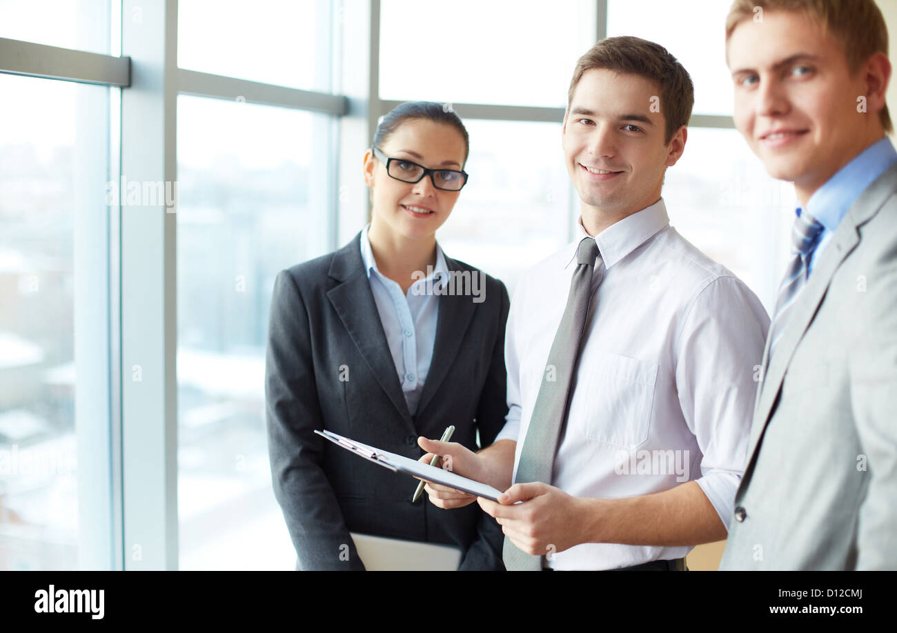 Image of three employees looking at camera, focus on elegant man with ...