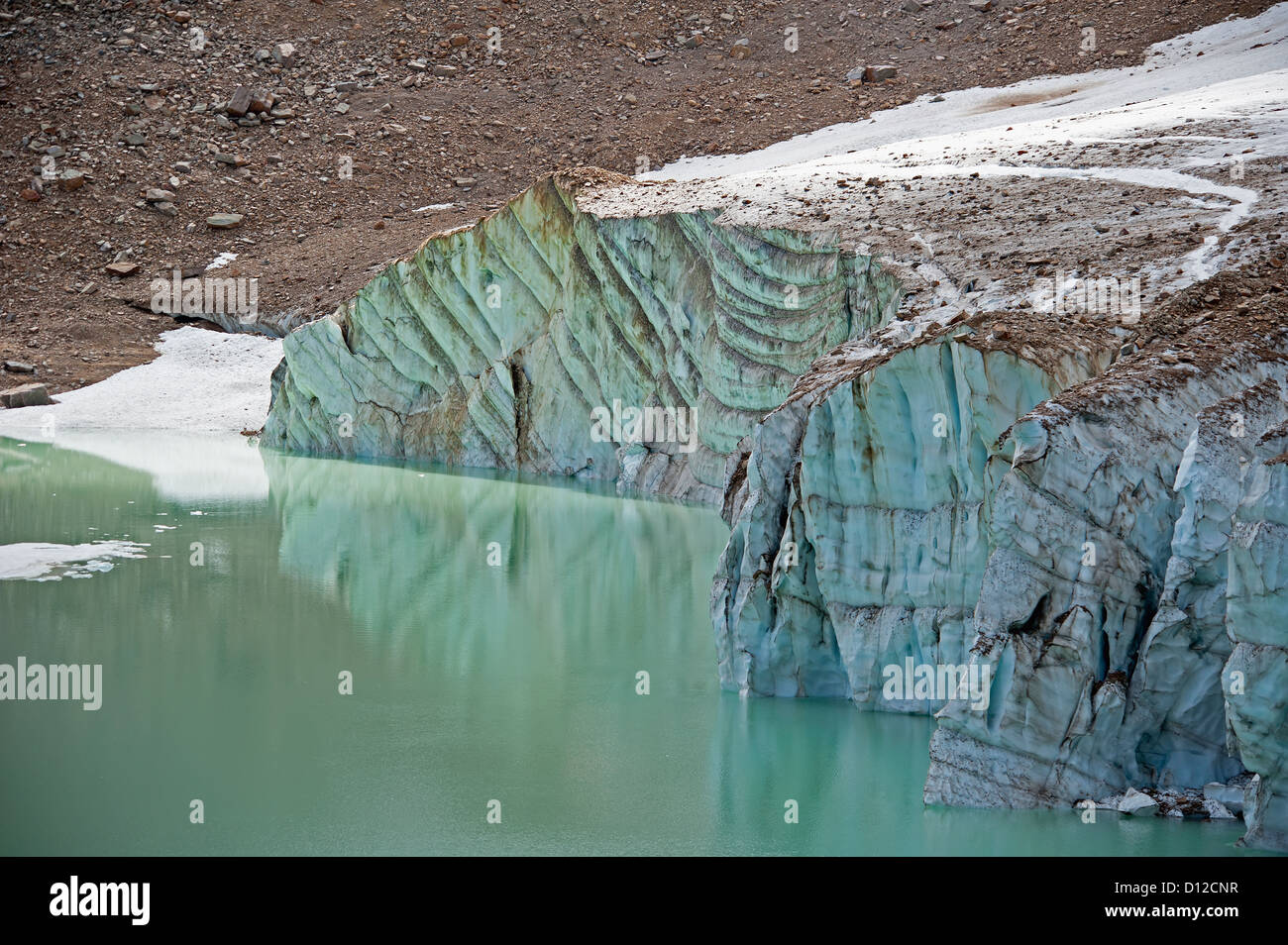 Rock Cliffs And Snow Reflected In The Water On Mount Edith Cavell ...