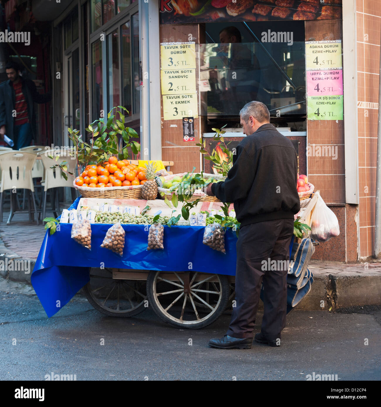 A Man Sells Nuts And Fruit From A Cart On The Street; Istanbul Turkey ...