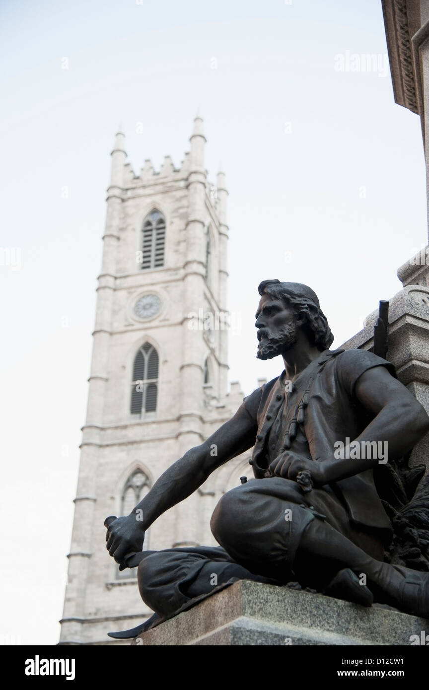 A Statue Of A Male Figure With A Clock Tower In The Background ...