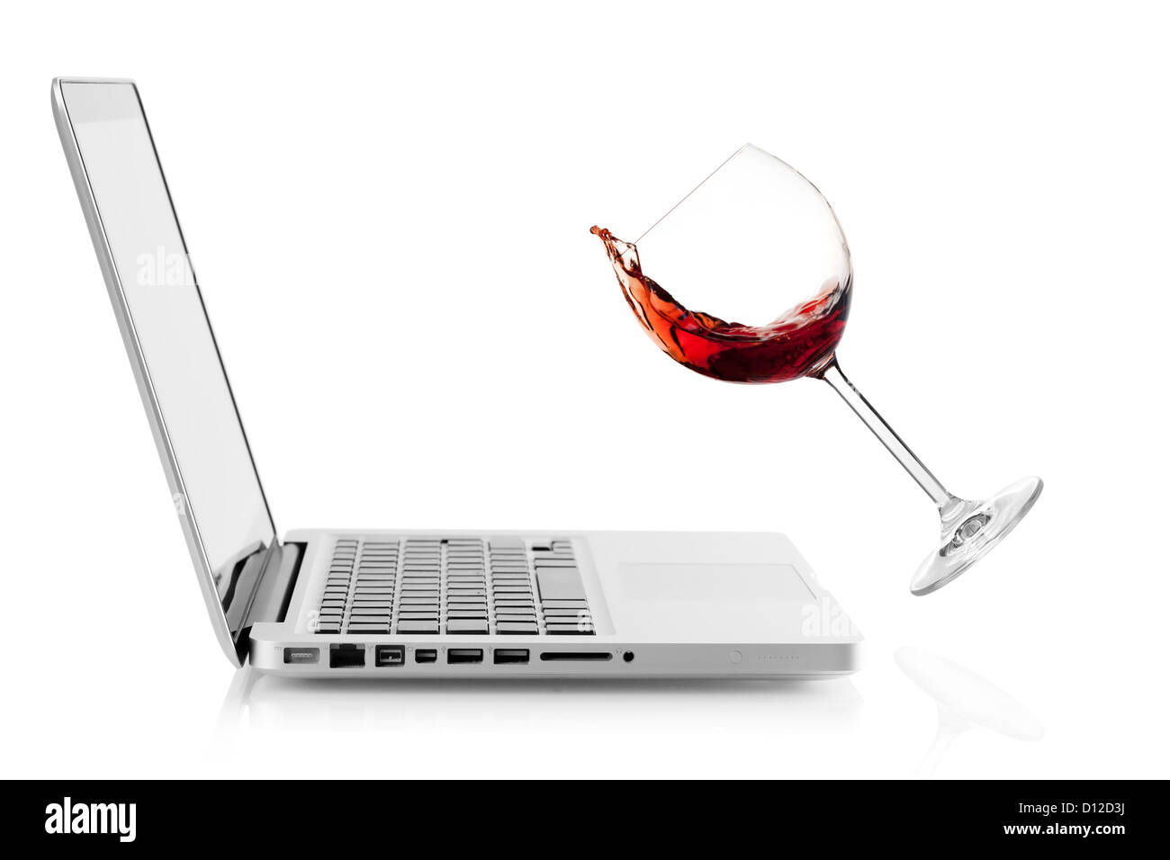 Wine falling on laptop. Isolated on white background Stock Photo - Alamy