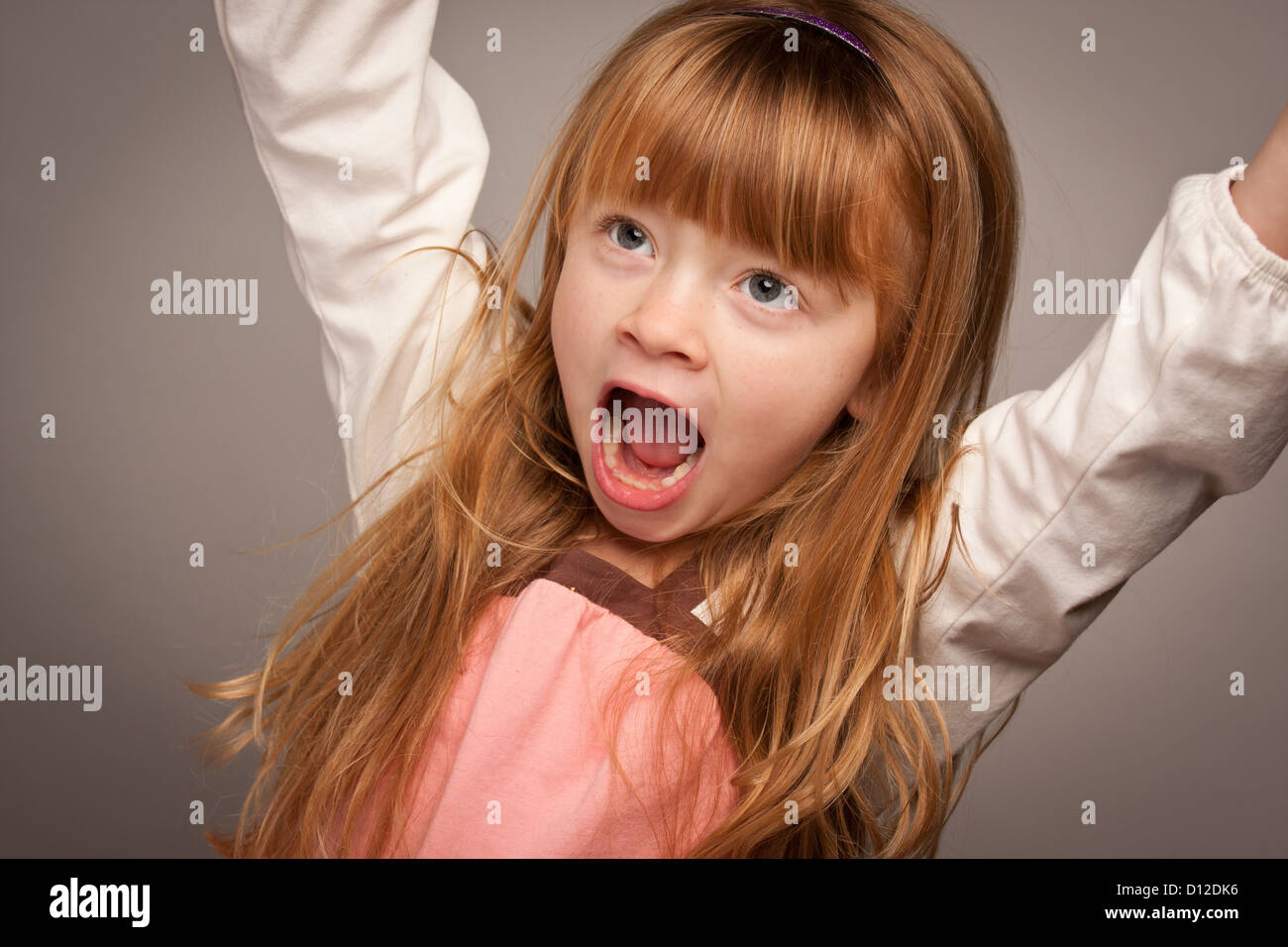 Fun Portrait of an Adorable Red Haired Girl on a Grey Background Stock ...