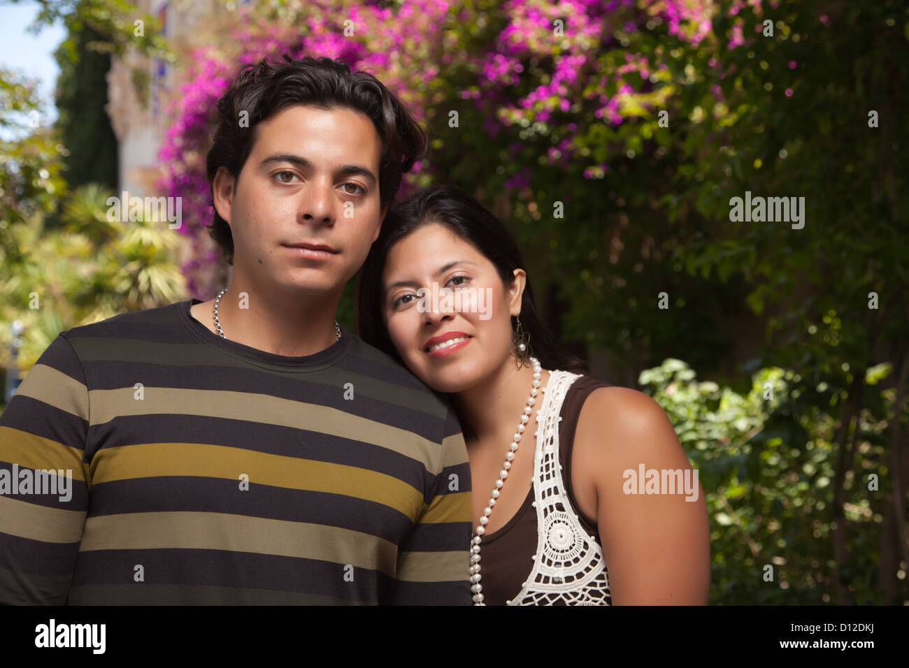 Attractive hispanic couple enjoying themselves at the park hi-res stock ...