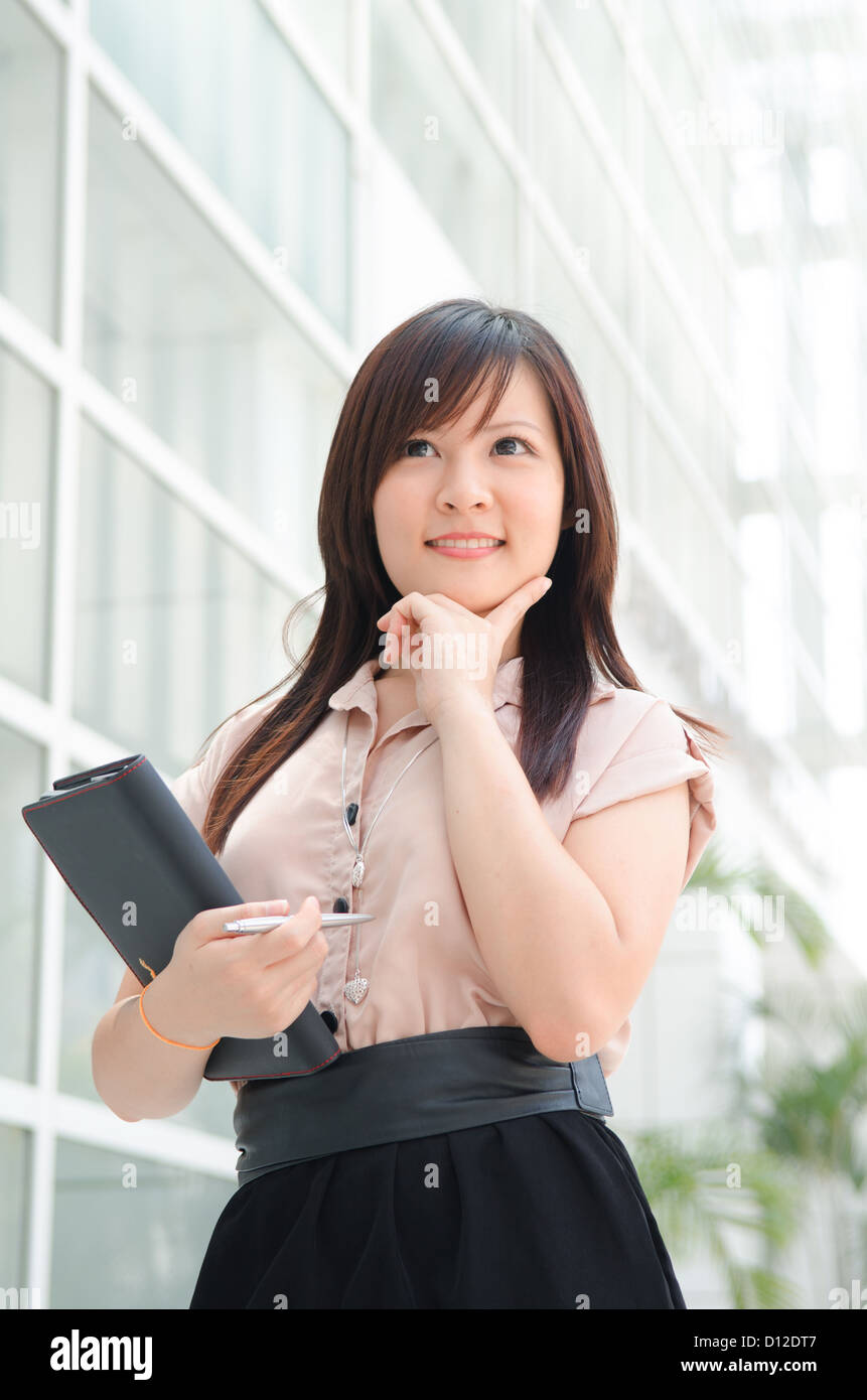 chinese female student in formal wear thinking Stock Photo - Alamy