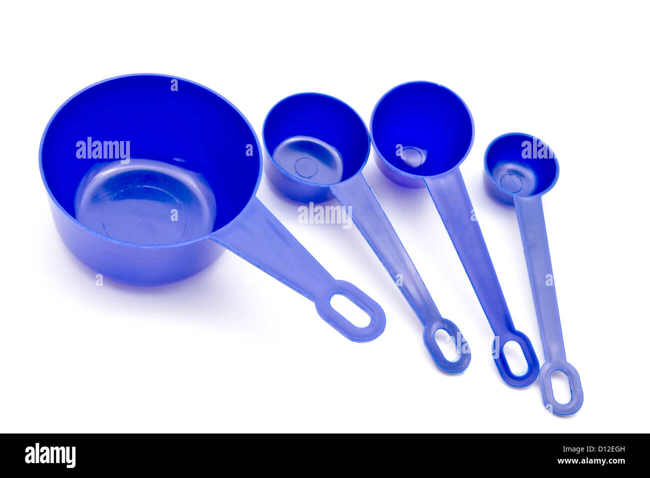 Blue measuring spoons closeup on white background Stock Photo - Alamy