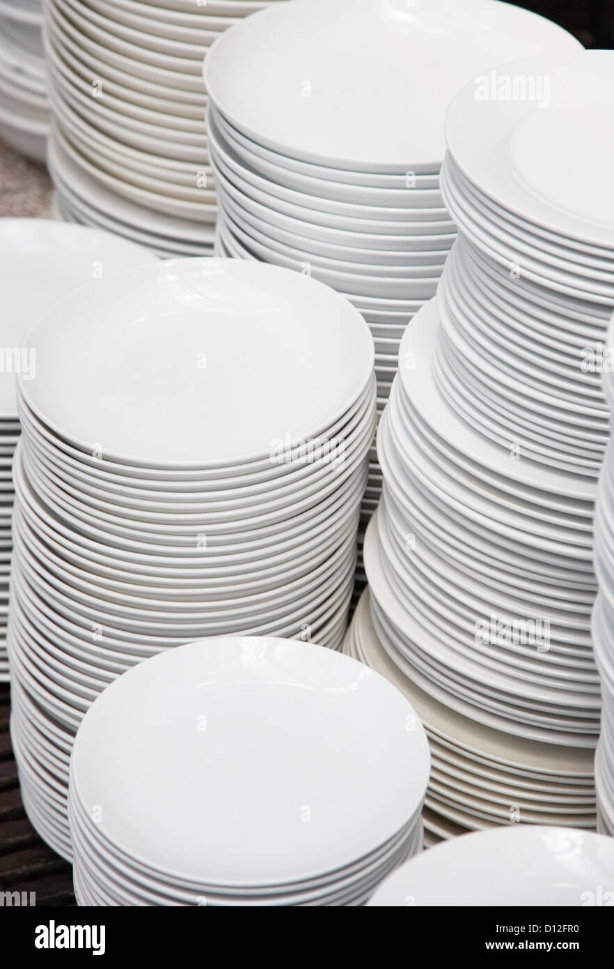Piles of clean white plates Stock Photo - Alamy