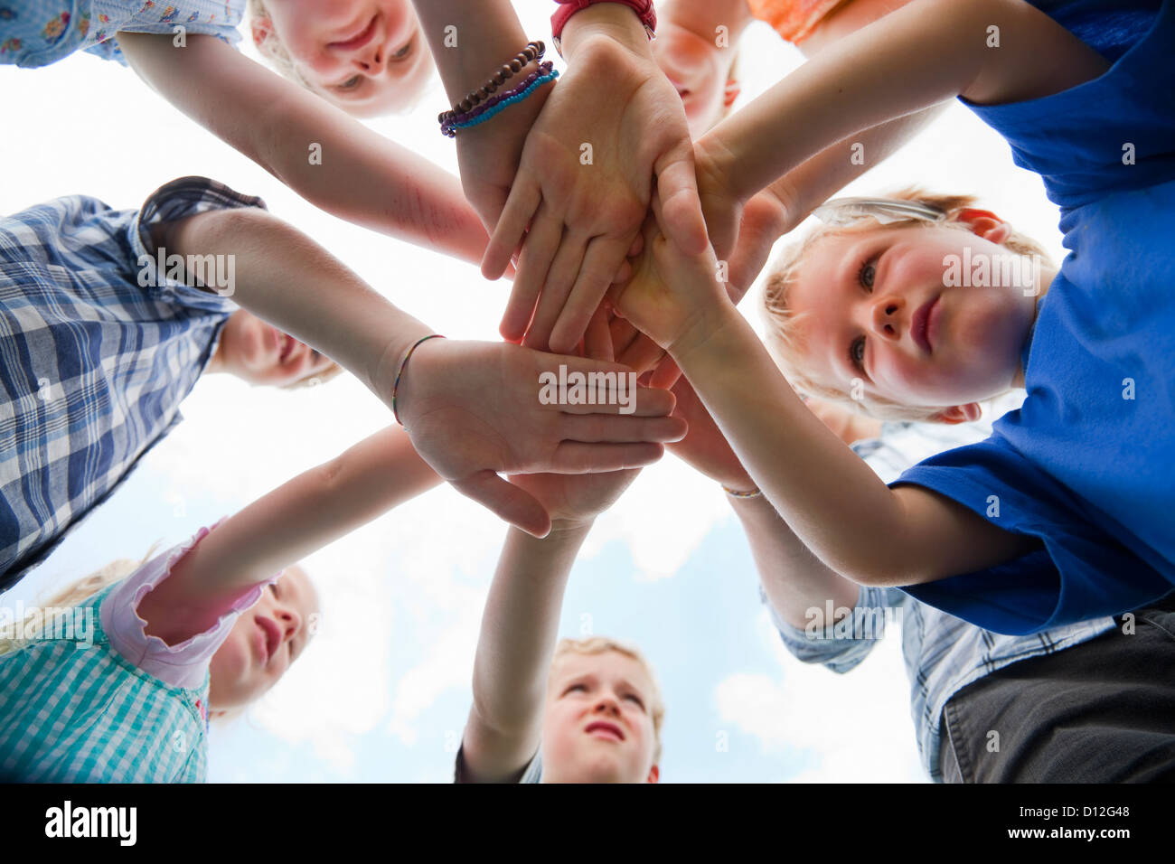 Children putting hands together hi-res stock photography and images - Alamy