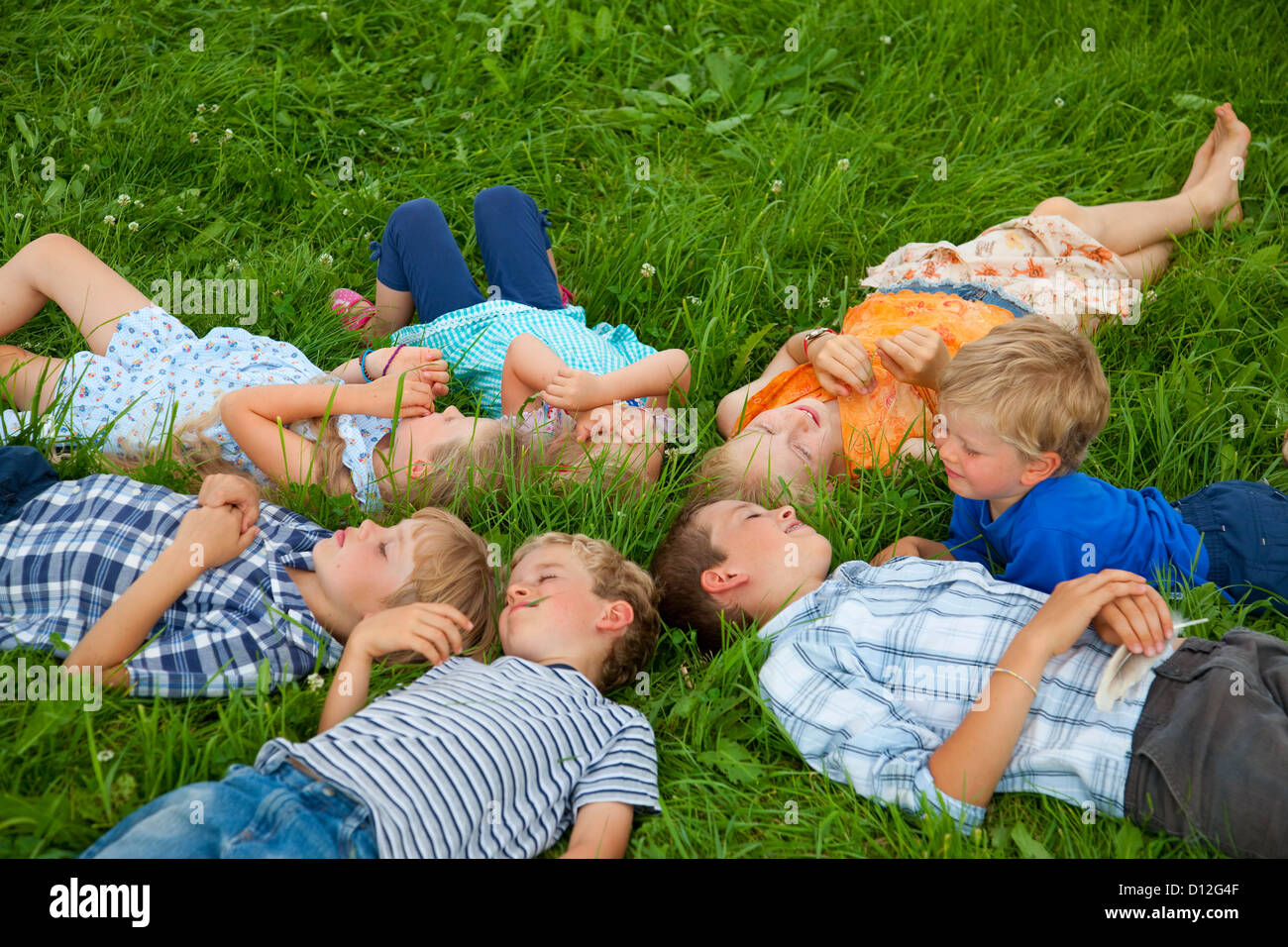 Germany, Bavaria, Group of children lying in meadow Stock Photo - Alamy