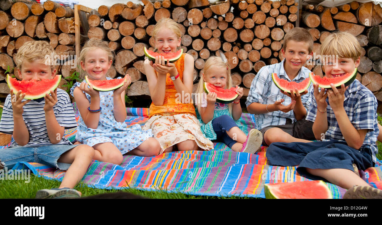 Germany, Bavaria, Group of children eating watermelon Stock Photo - Alamy