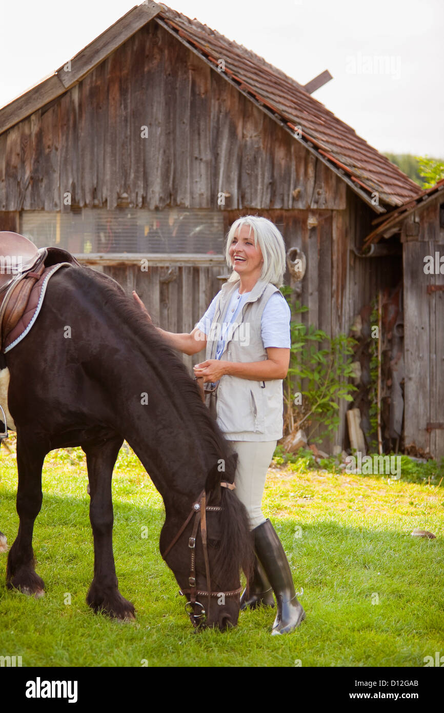 Woman standing grazing horse hi-res stock photography and images - Alamy