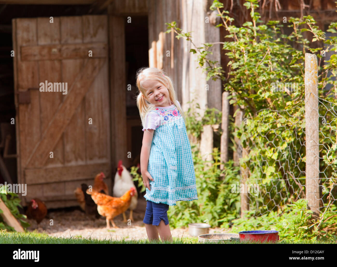 Germany, Bavaria, Girl with chicken on farm Stock Photo - Alamy