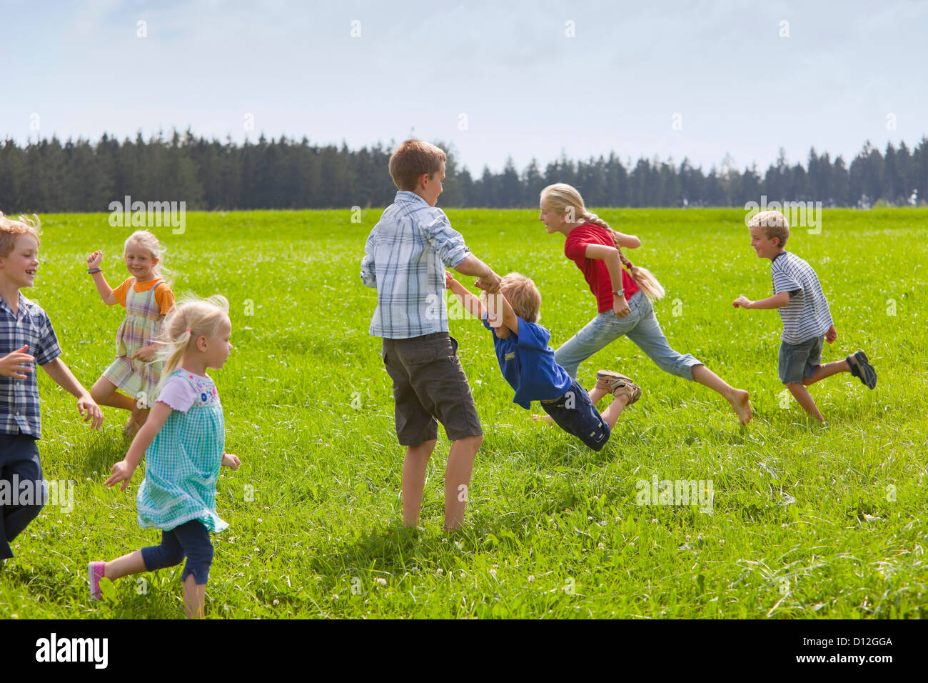 Germany, Bavaria, Group of children playing in meadow Stock Photo - Alamy