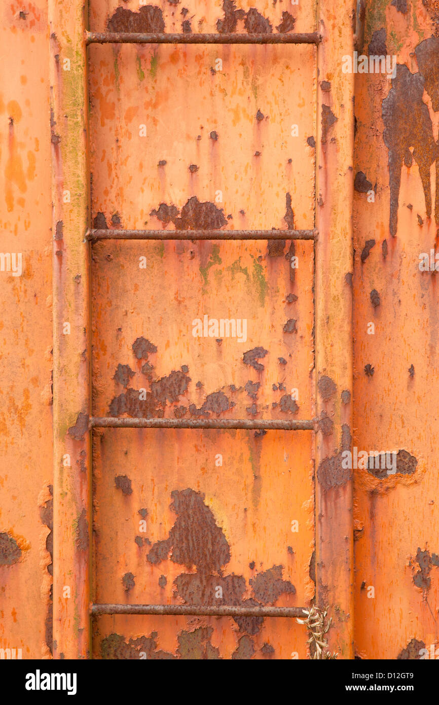 four steps of old orange and rusty container on vertical image Stock ...