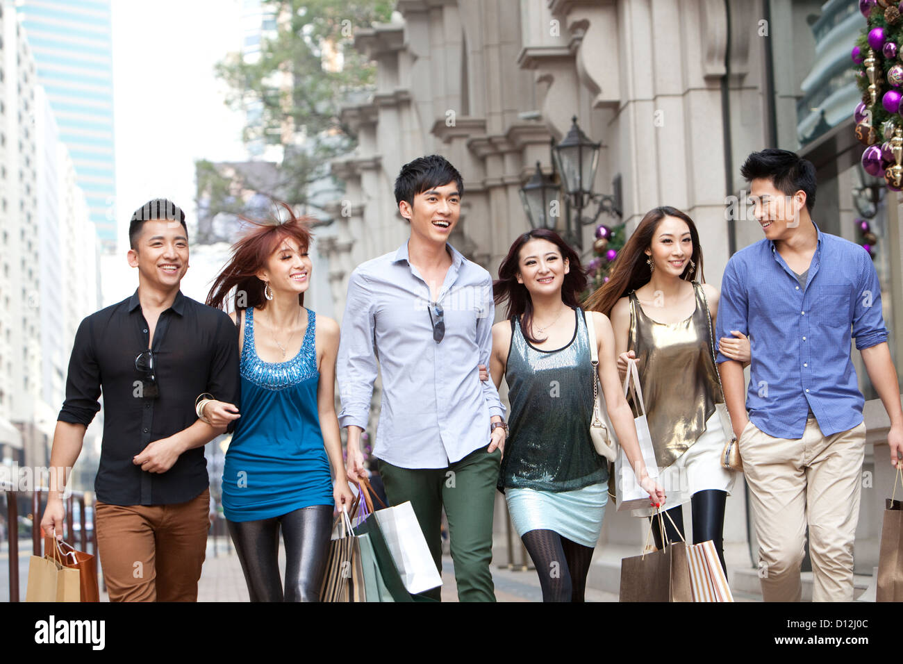 Excited young people go shopping on the street of Hong Kong Stock Photo ...