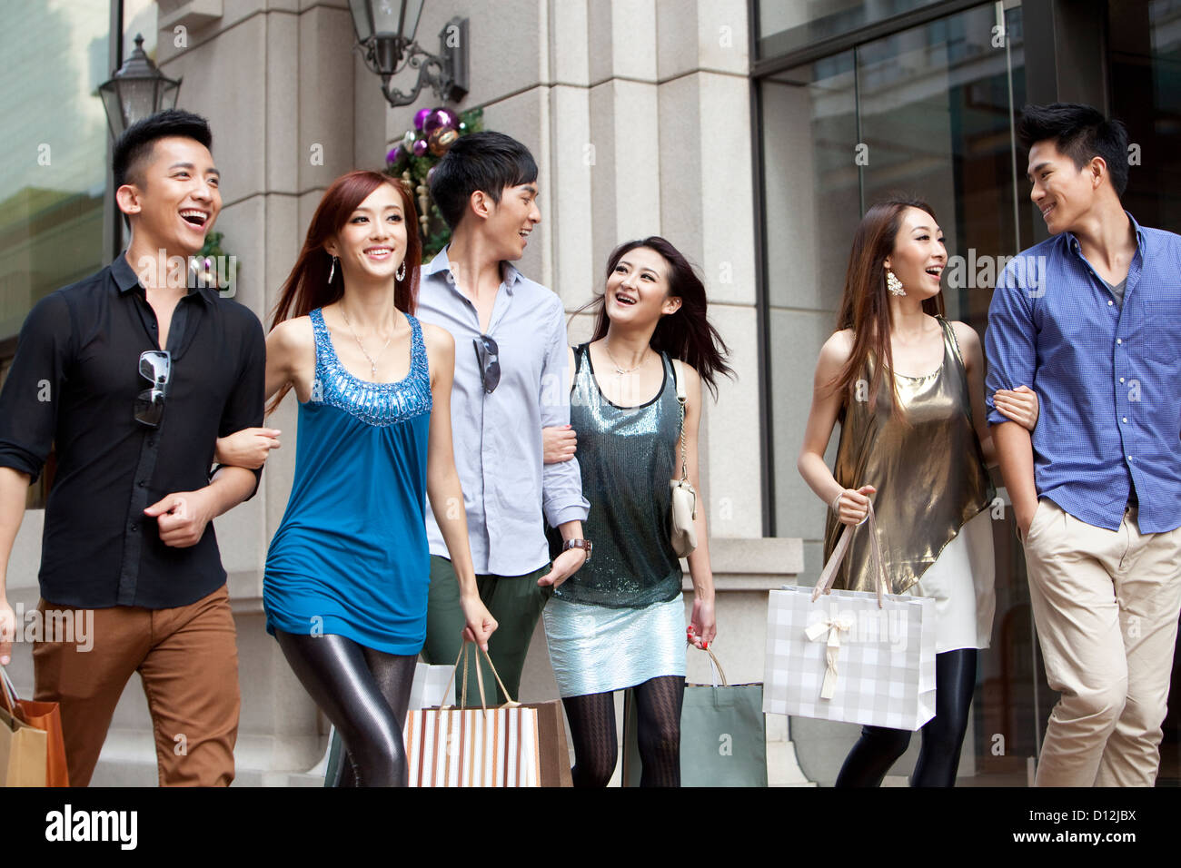 Excited young people go shopping on the street of Hong Kong Stock Photo ...