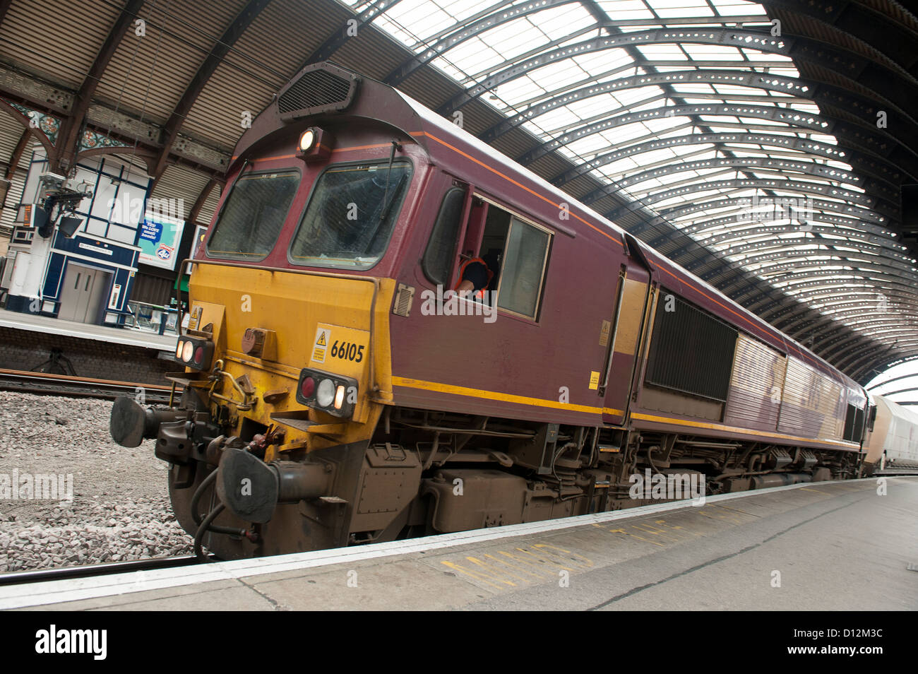 Class 66 freight locomotive in EWS liery at the head of a freight train ...